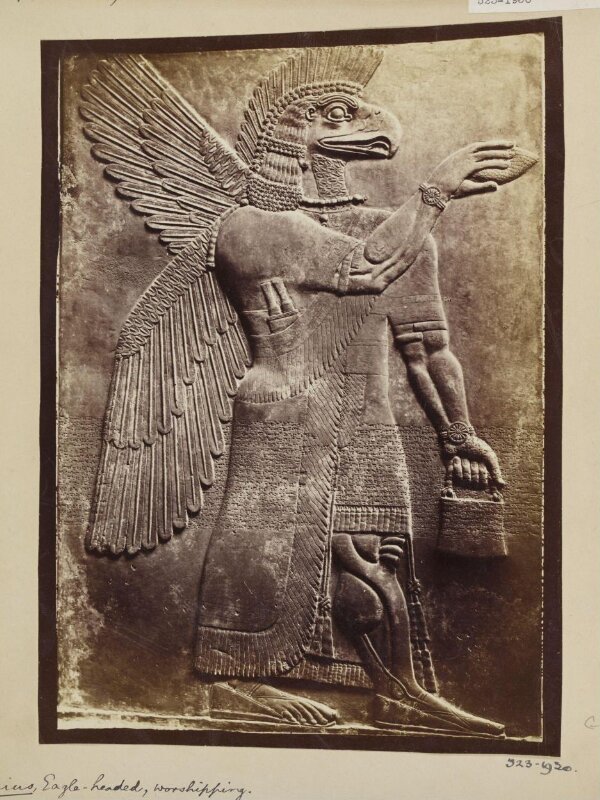 Assyrian sculpture of an eagle-headed genius, worshipping, Paris ...